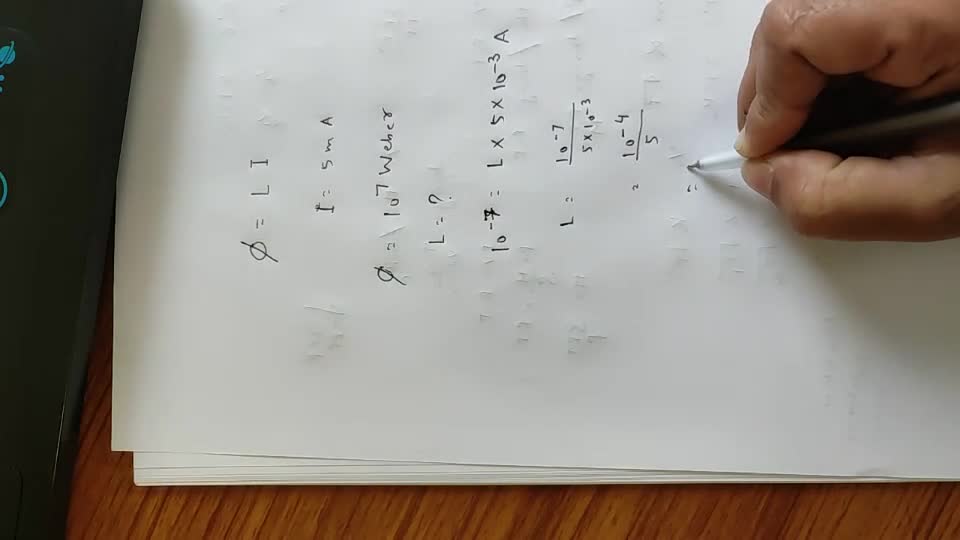 A coil of 100 turns carries a current of 5mA and creates a magnetic flux..